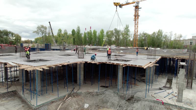 Large Crane Operates while Support Structures Hold Framework in Place ...