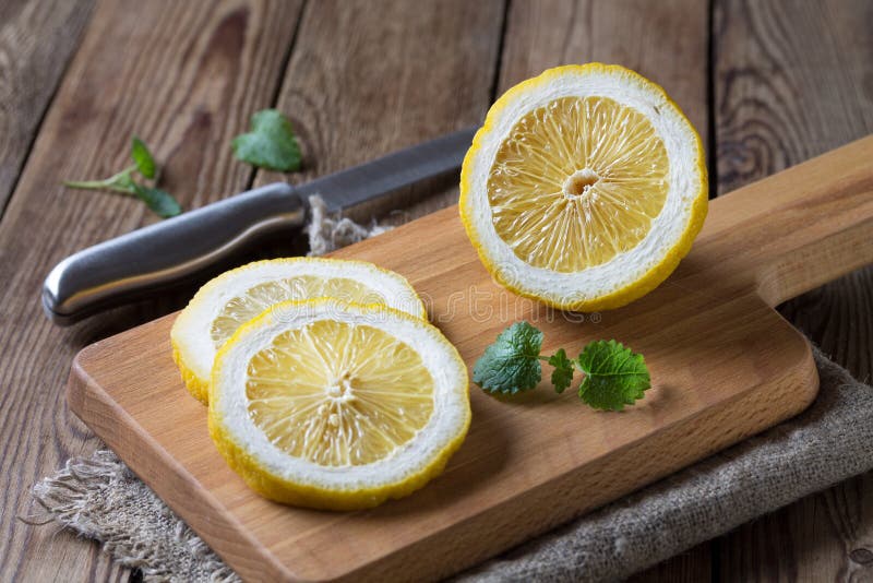 Large Cut Lemon on the Kitchen Board. Natural Textiles and Background ...