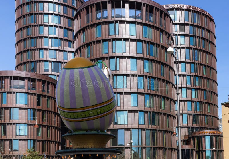 A Large Decorative Easter Egg Against a Modern Building in the City of ...