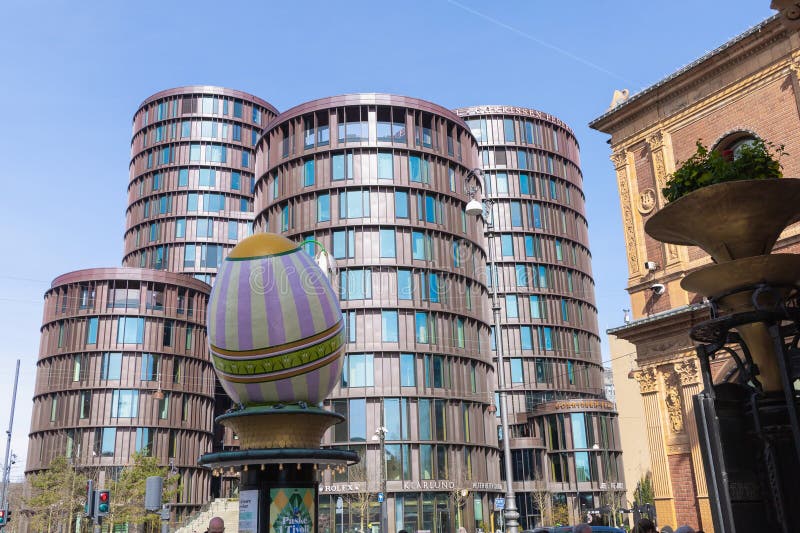 A Large Decorative Easter Egg Against a Modern Building in the City of ...