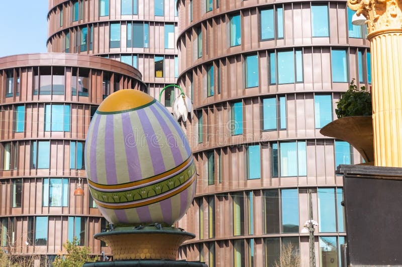A Large Decorative Easter Egg Against a Modern Building in the City of ...