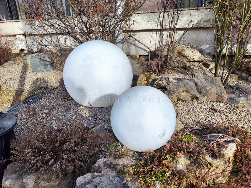 Large Decorative Orbs in a Minimalist Garden Setting Surrounded by ...