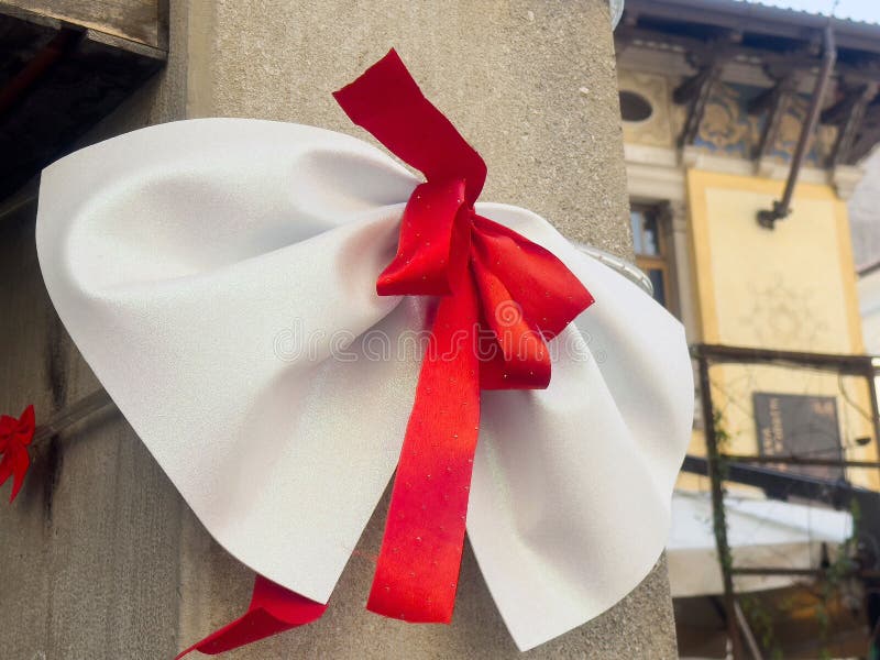Large Decorative White Bow with Red Ribbon Attached To Stone Pillar in ...
