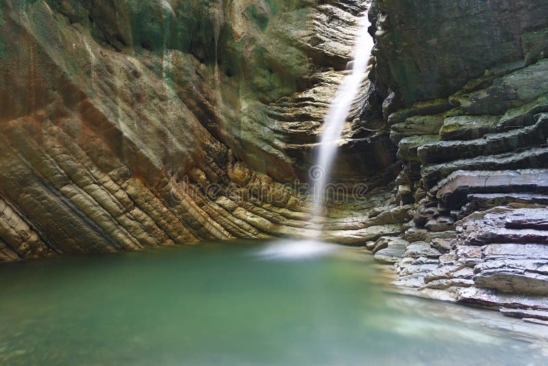 Large Deep Grotto with Flowing Beautiful Waterfall Stock Image - Image ...