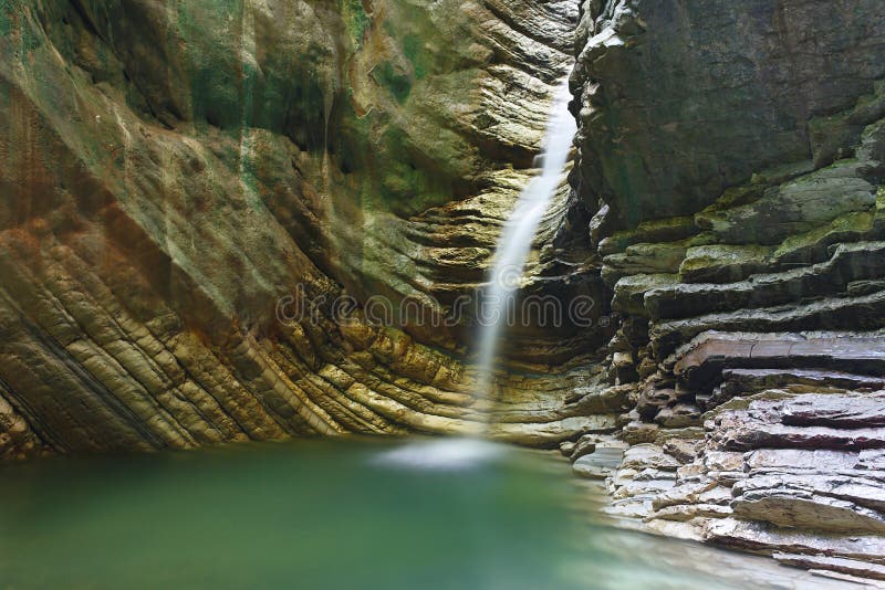 Large Deep Grotto with Pouring Beautiful Waterfall Stock Image - Image ...