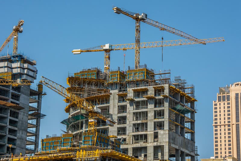 Large Development Construction Site with Yellow Cranes and Scaffolding ...