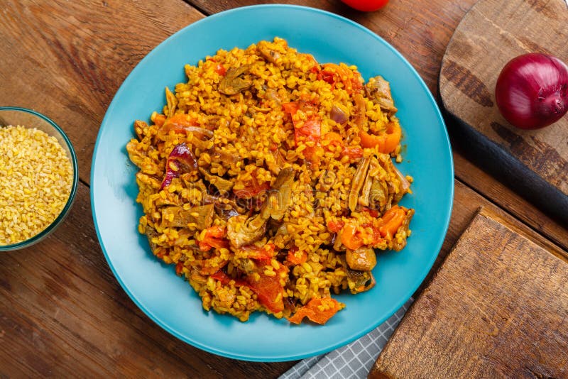 A Large Dish of Bulgur with Vegetables and Mushrooms in Spices on the ...