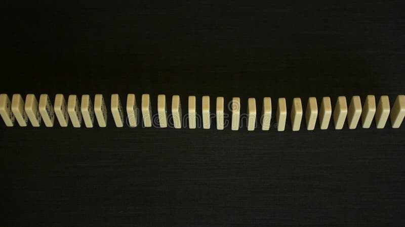 Domino Effect in Slow Motion - Falling Black Tiles with White Dots ...