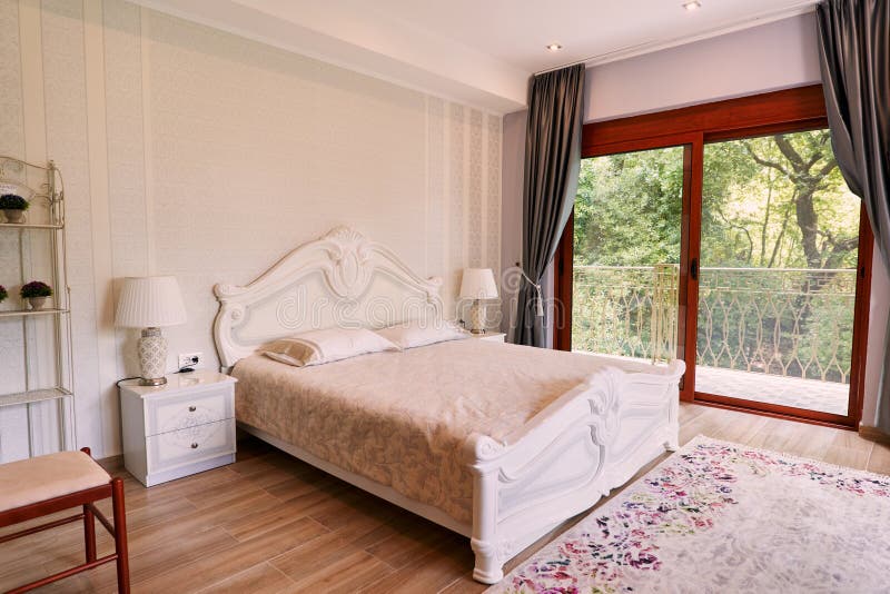 Large Double Bed with Bedside Tables in a Room with Panoramic Windows ...