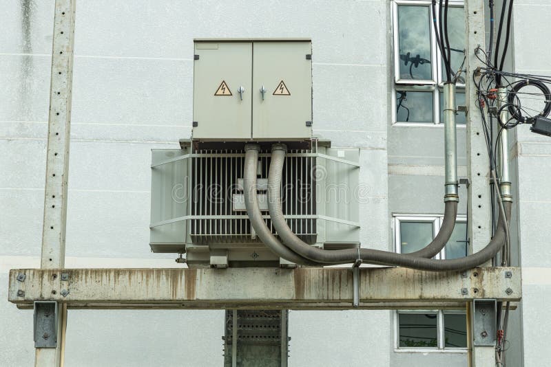 A Large Eletric Transformer is Mounted on Concrete Beams and Poles ...