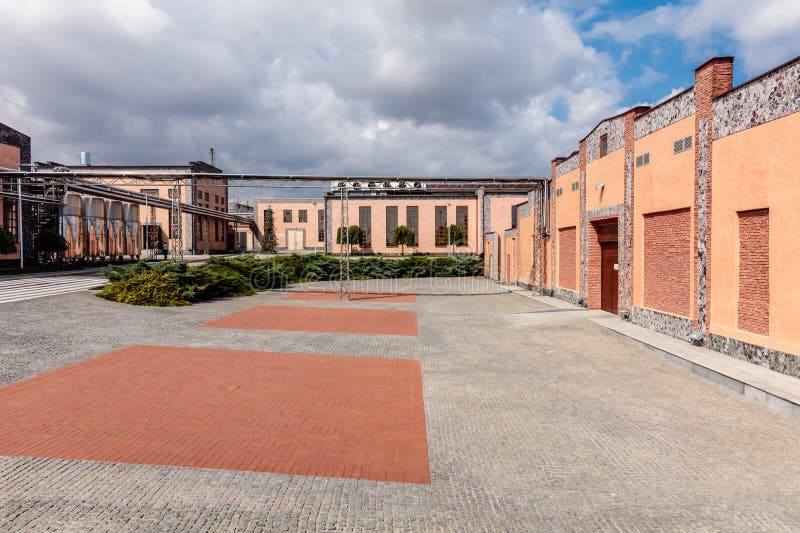 A Large Empty Courtyard with a Few Trees and a Few Buildings Stock ...
