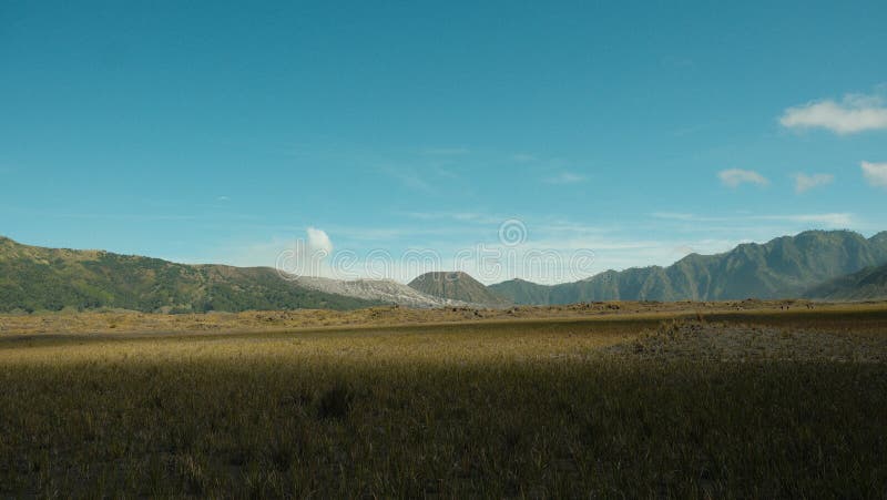 A Large, Empty Field with a Blue Sky in the Background Stock Photo ...