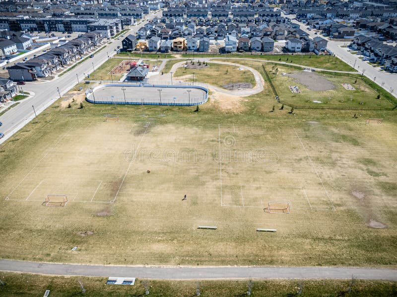 Large Empty Field with a Few Trees and a Few Houses in the Background ...