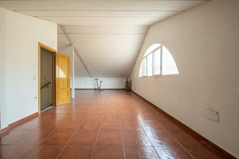A Large Empty Hall of a Detached House in the Attic with Dormer Windows ...