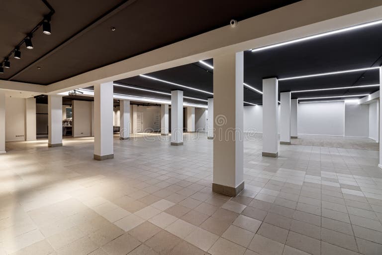 A Large Empty Room with Ceramic Tiles on the Floor, a Black Ceiling ...