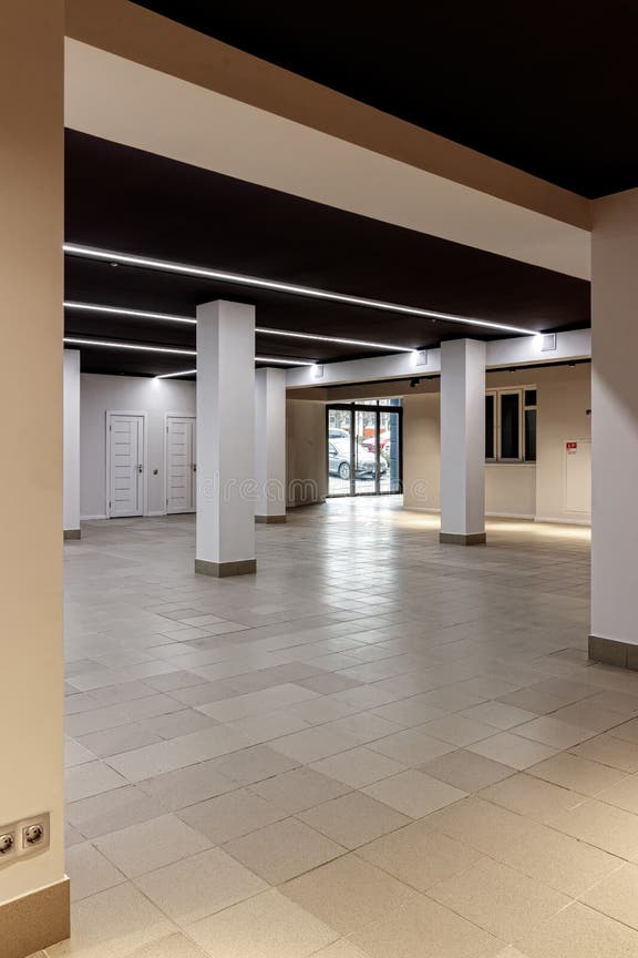 A Large Empty Room with Ceramic Tiles on the Floor, a Black Ceiling ...