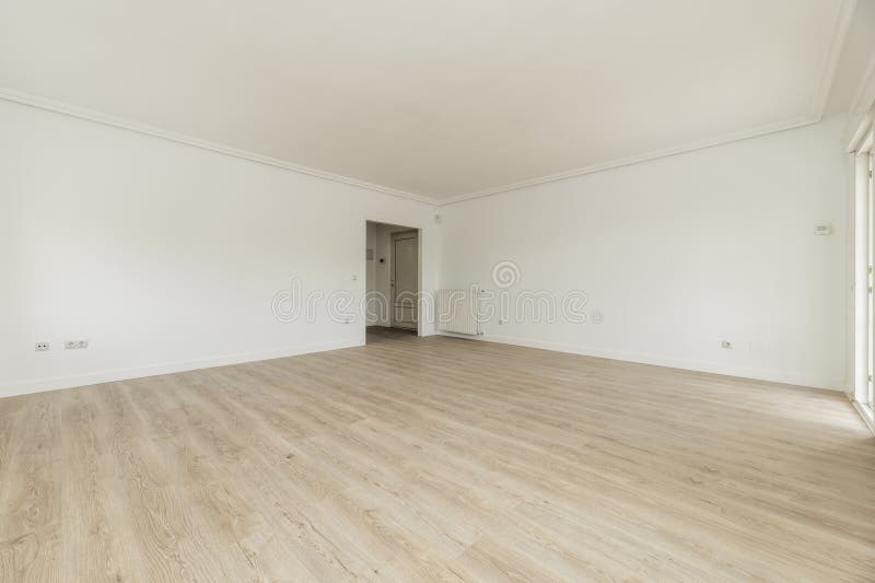 Large Empty Room with Plain White Painted Walls and Light Wooden Floors ...
