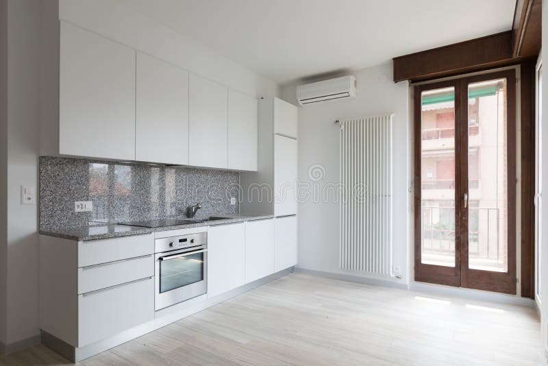 Large Empty Room with White Walls and Modern Kitchen Stock Photo ...