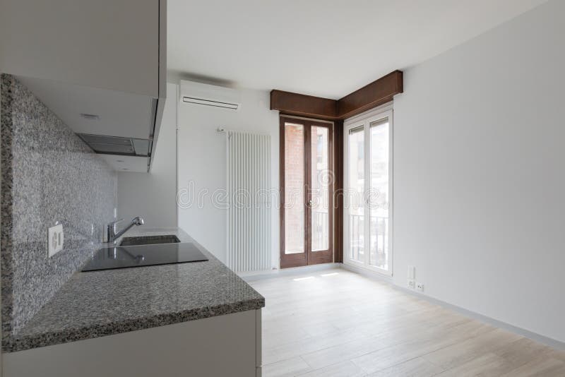 Large Empty Room with White Walls and Modern Kitchen Stock Photo ...