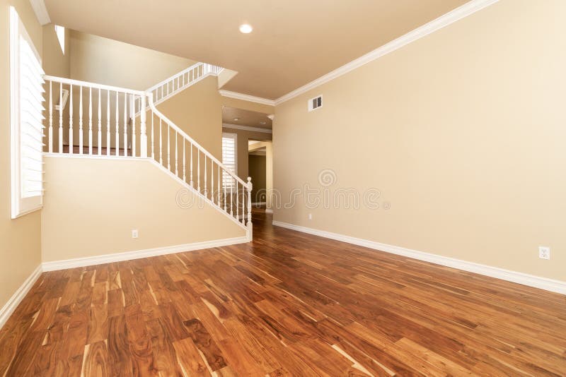 Large Empty Room with Wood Floor, Molding and Windows and Stairs. Stock ...