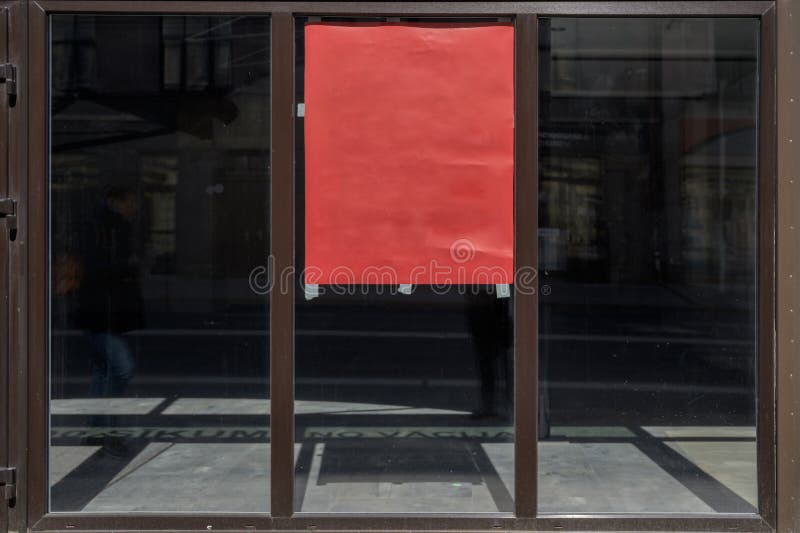 A Large Empty Storefront with a Red Poster on the Glass. Shop for Rent ...