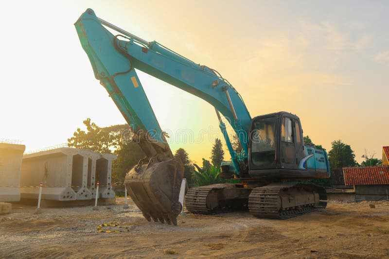 A Large Excavator or Backhoe Green and Blue Construction Machine is ...