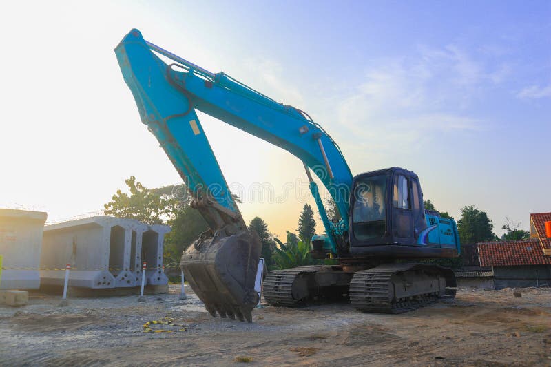 A Large Excavator or Backhoe Green and Blue Construction Machine is ...