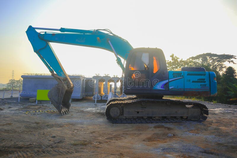 A Large Excavator or Backhoe Green and Blue Construction Machine is ...