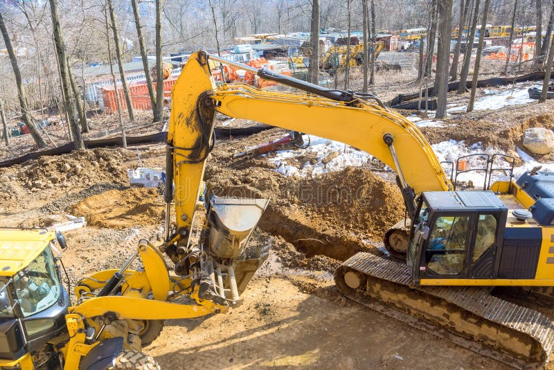 A Large Excavator is Digging on an Industrial Site for Development of ...