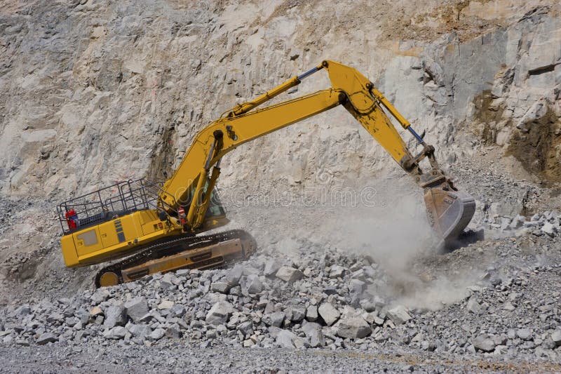 Yellow Excavator in a Mine. Stock Photo - Image of rocks, gold: 99924736