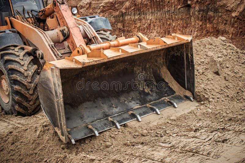 Excavator Digging in a Construction Site during Daylight, Moving Earth ...