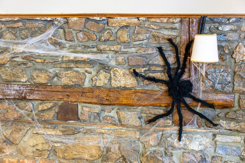 Large Fake Spider on Rustic Stone Wall with Cobwebs for Halloween Decor ...