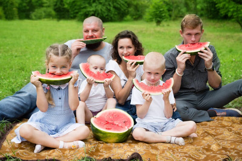 Large Family Eating Watermelon Stock Photo - Image of friendship ...