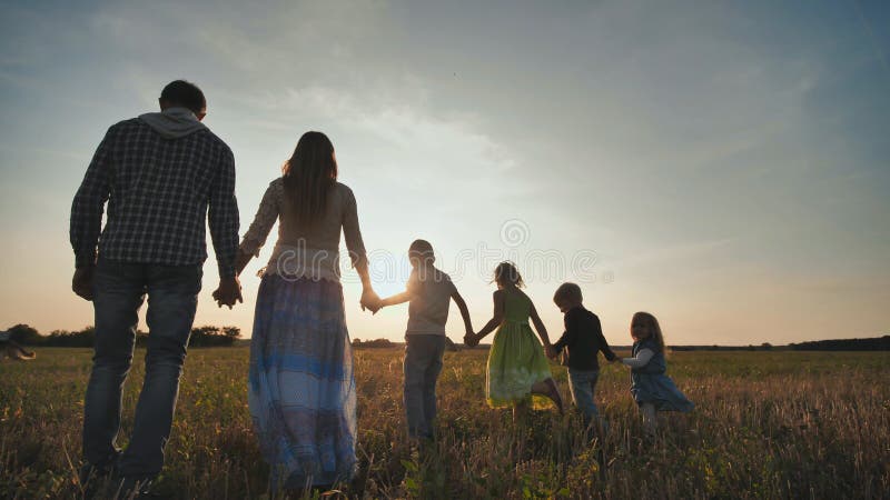 A Large Family of Six People Walk on the Floor at Sunset. Stock Image ...