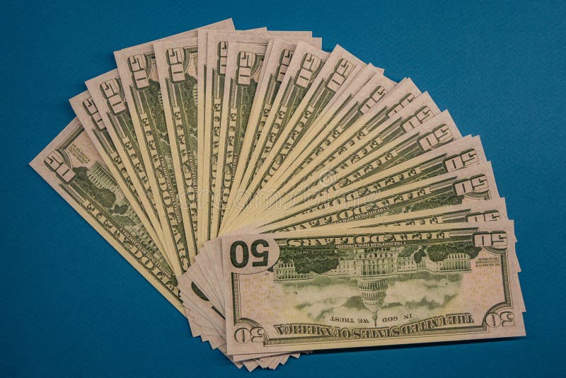 Large Fat Money Roll Isolated on a Blue Background Stock Photo - Image ...