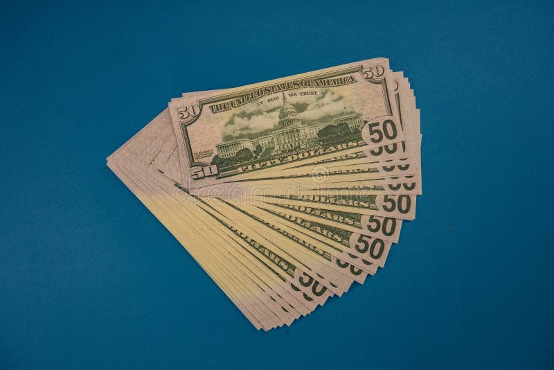 Large Fat Money Roll Isolated on a Blue Background Stock Photo - Image ...