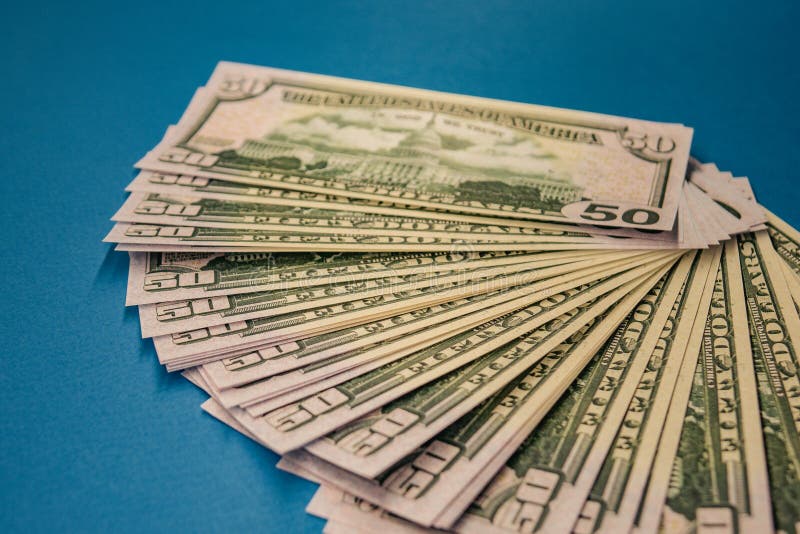 Large Fat Money Roll Isolated on a Blue Background Stock Photo - Image ...
