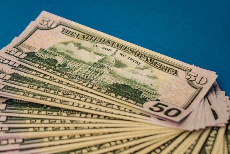 Large Fat Money Roll Isolated on a Blue Background Stock Photo - Image ...