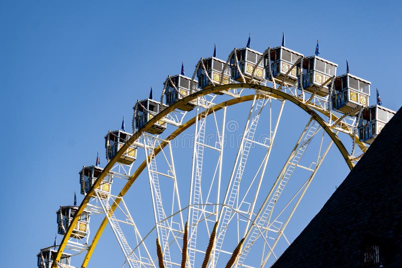 A Large Ferris Wheel with Many Cabins on it Stock Image - Image of ...