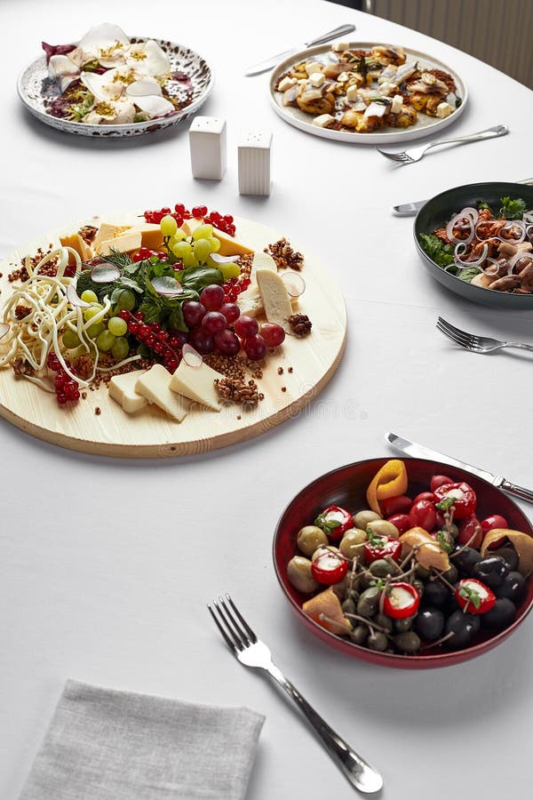 Large Festive Table with Different Appetizers, Assorted Cheeses, Salads ...