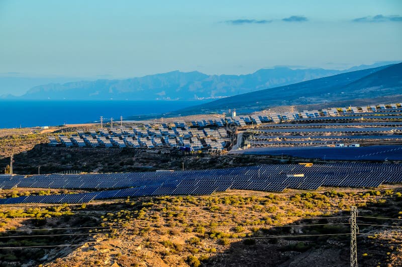 A Large Field of Solar Panels is Visible in the Distance Stock Photo ...