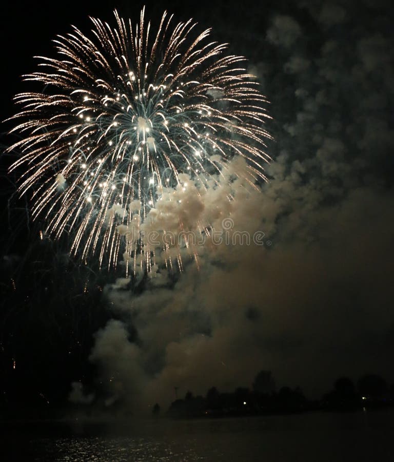 One Large Firework with Three Small Firework Bursts Stock Image - Image ...