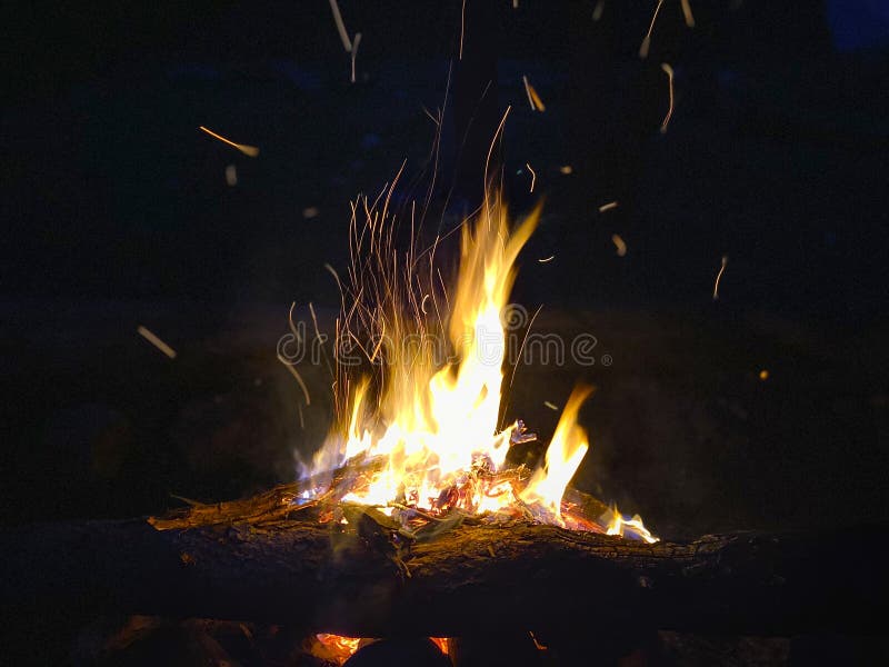A Large Flaming Bonfire with Sparks and Particles at Night Stock Image ...