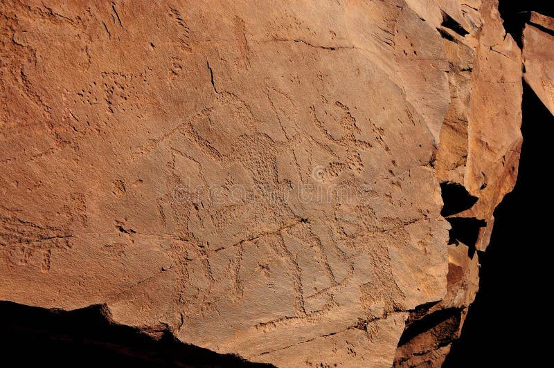 A Large Flat Red Stone with Ancient Drawings on the Surface Stock Photo ...