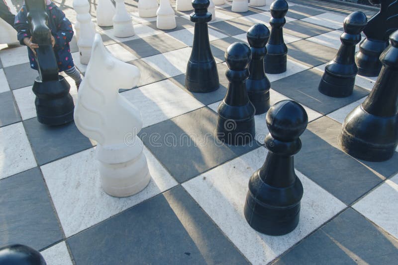 Large Floor Chess. Large Chess Pieces for Fun in the Park. Stock Photo ...