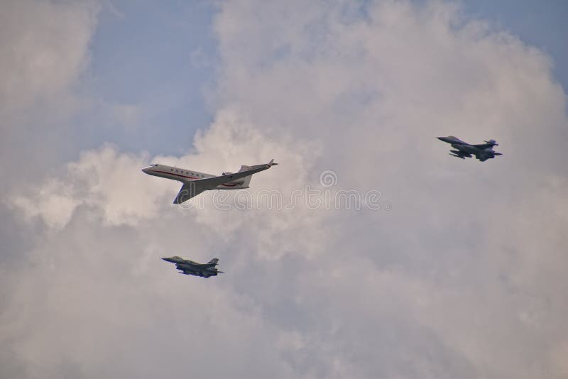Flying Combat Aircraft Against the Blue Sky with Clouds on a Sunny Day ...