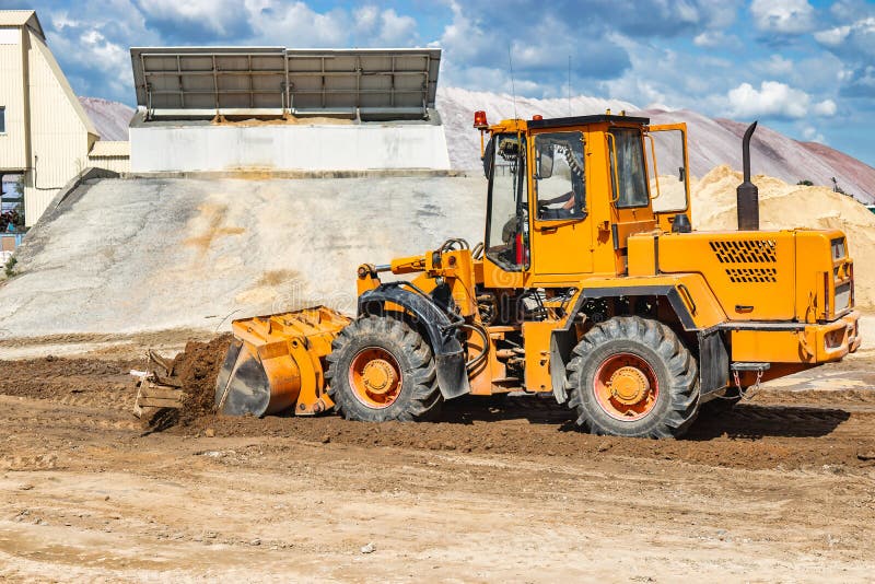 A Large Front Loader Pours Sand into a Pile at a Construction Site ...