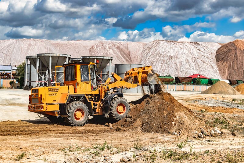 A Large Front Loader Pours Sand into a Pile at a Construction Site ...