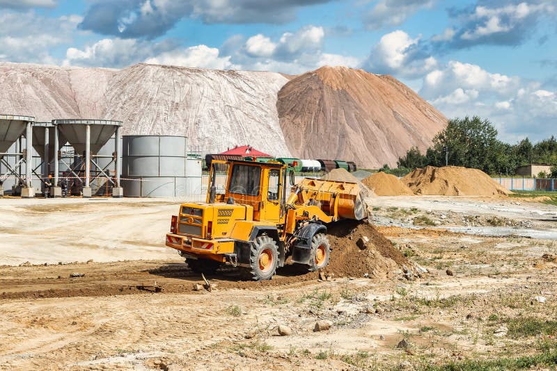 A Large Front Loader Pours Sand into a Pile at a Construction Site ...