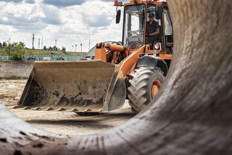 A Large Front Loader Pours Sand into a Pile at a Construction Site ...